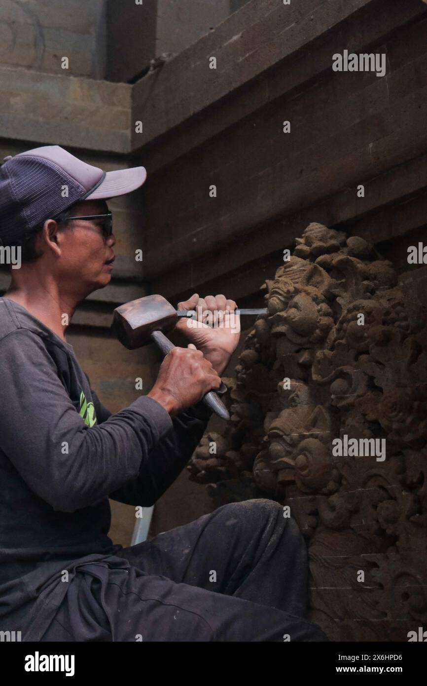 A stone sculptor intricately carves statues in Bali, shaping the island ...