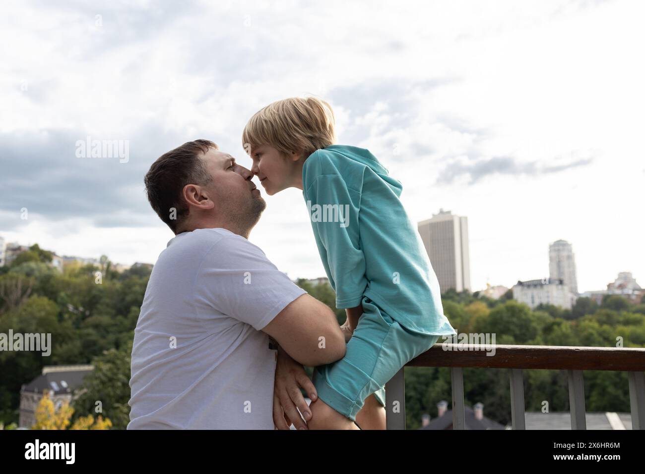 wo people - father and son touch each other with their noses. tenderness, paternal care ...