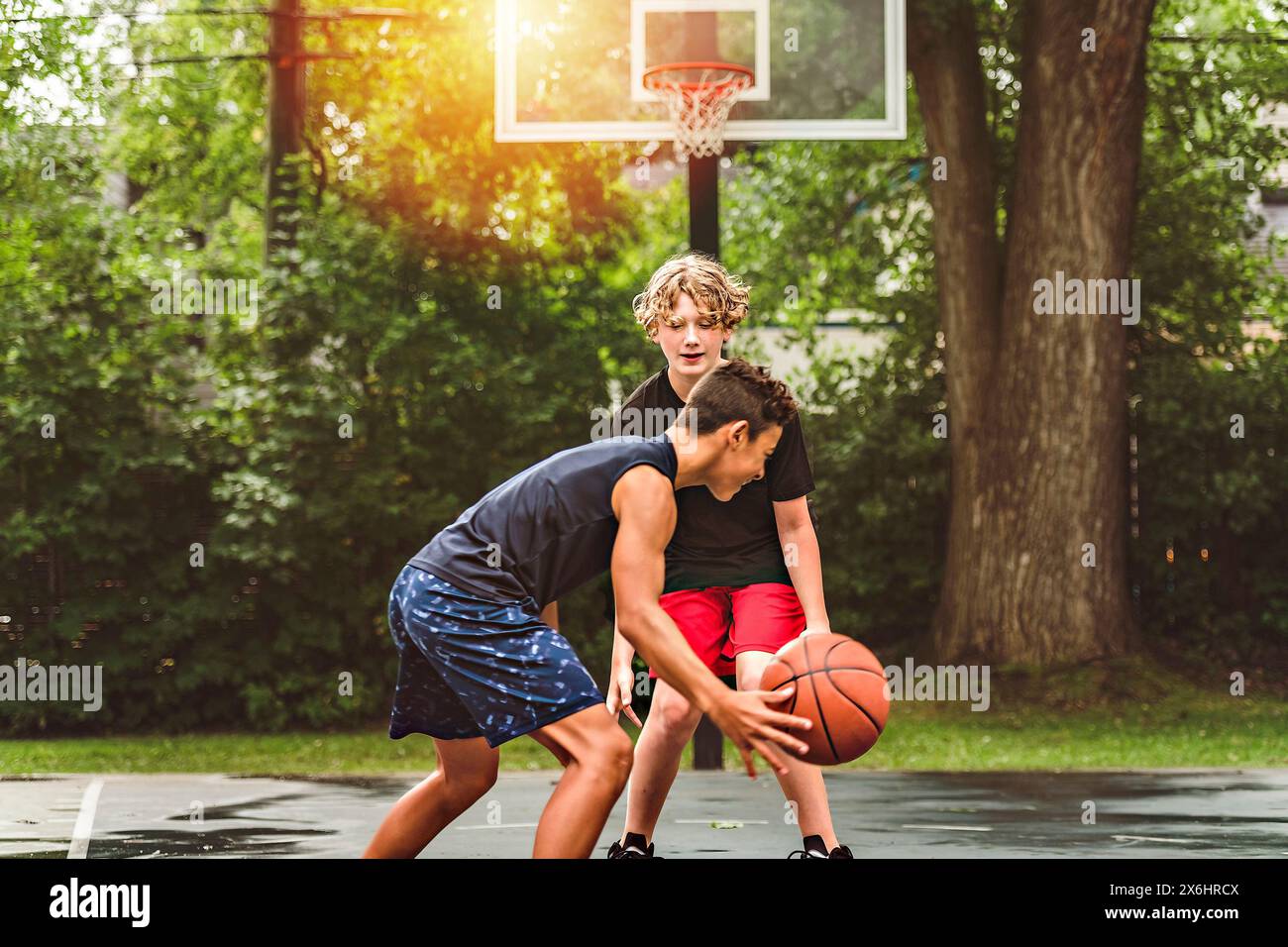 two teens in sportswear playing basketball game Stock Photo - Alamy