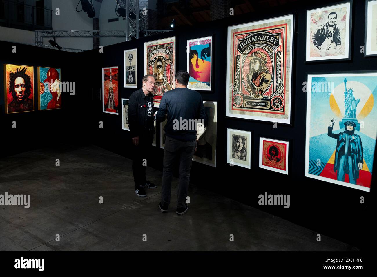 Milano, Italy. 15th May, 2024. Shepard Fairey is talking with a visitor ...