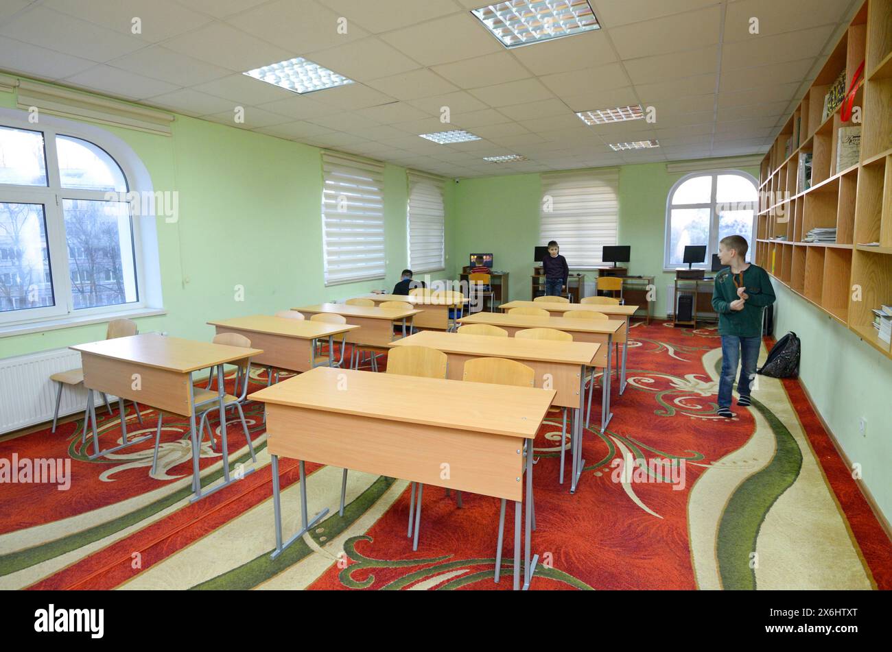Class-room of the medrese: school desks, shelves with books and Muslim ...