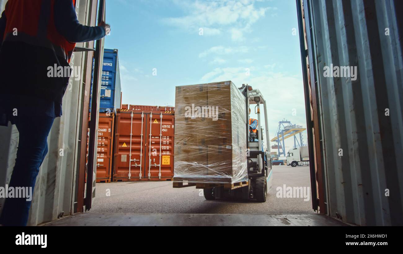 Forklift Driver Loading a Shipping Cargo Container with a Full Pallet ...