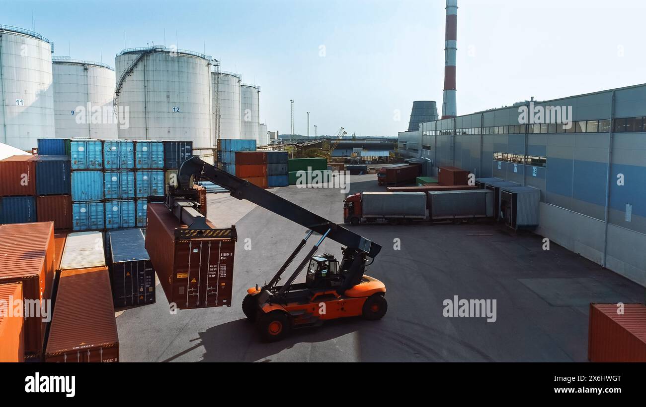 Aerial Shot of a Container Handler Carrying a Large Red Shipping Cargo ...