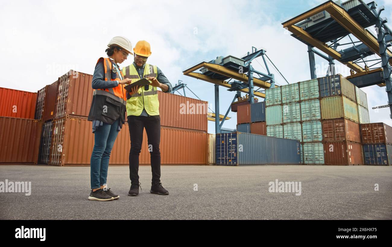 Multiethnic Female Industrial Engineer with Tablet and Black African ...
