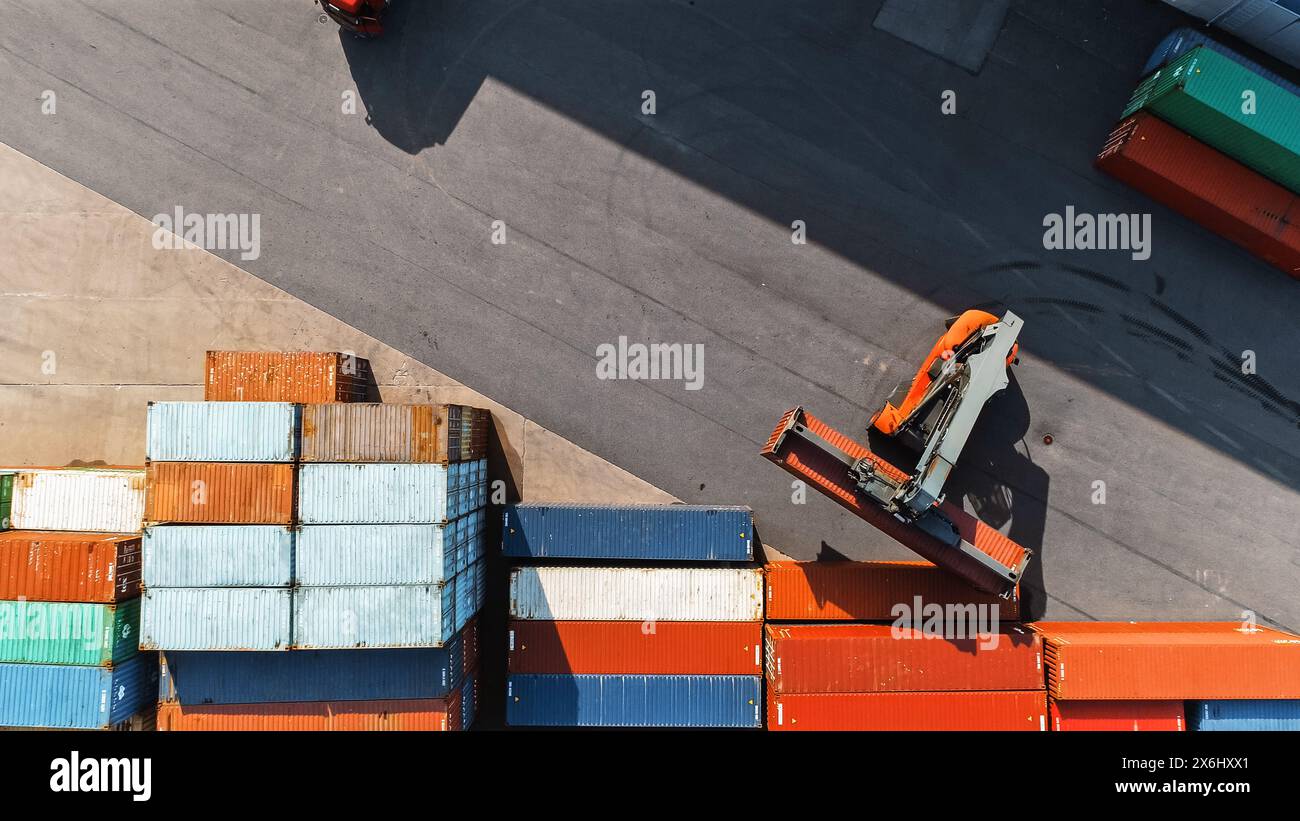 Aerial Top Down Shot of a Container Handler Carrying a Large Red Cargo ...