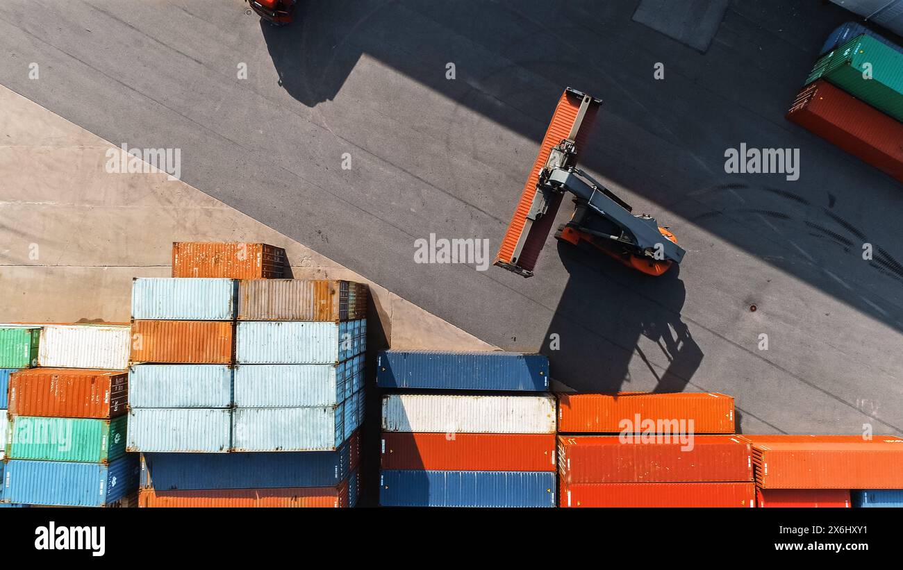 Aerial Top Down Shot of a Container Handler Carrying a Large Red Cargo ...