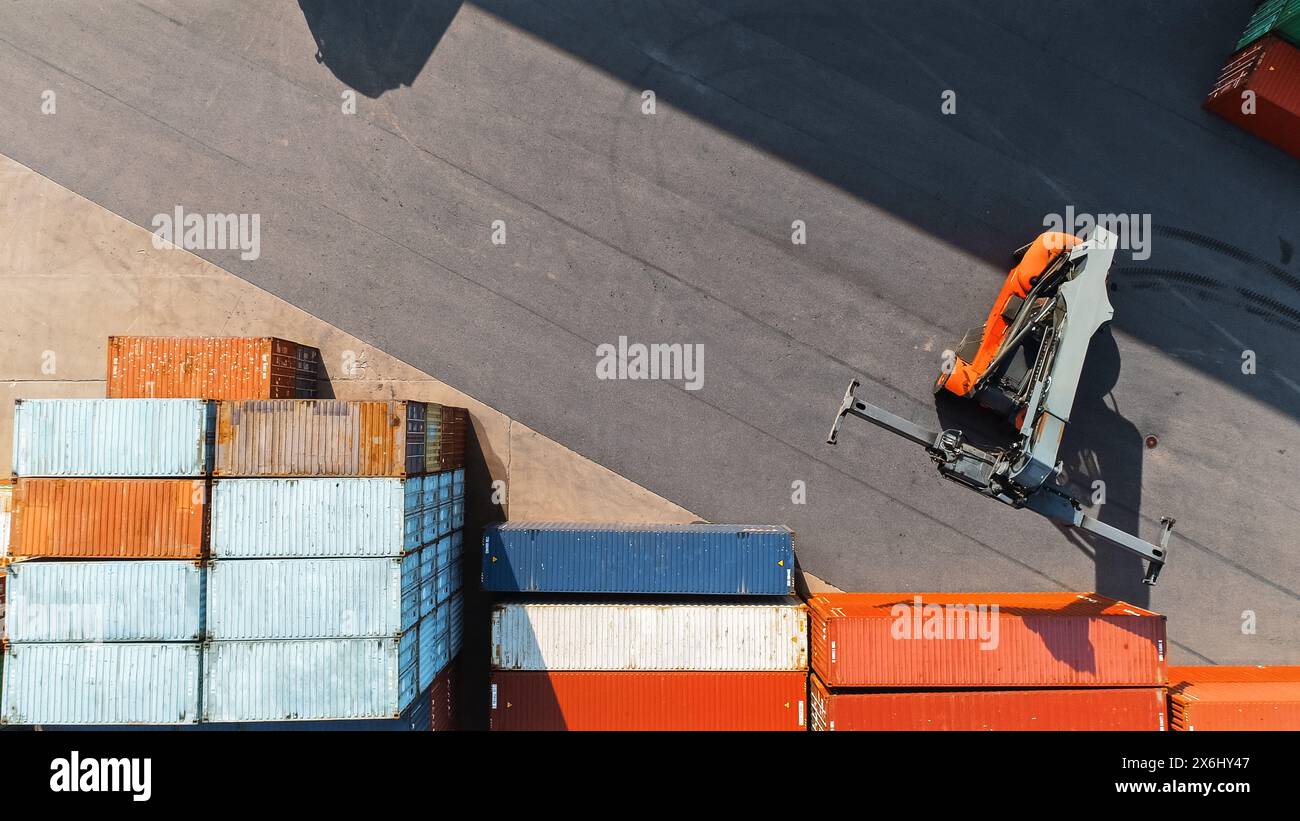 Aerial Top Down Shot of a Container Handler Carrying a Large Red Cargo ...