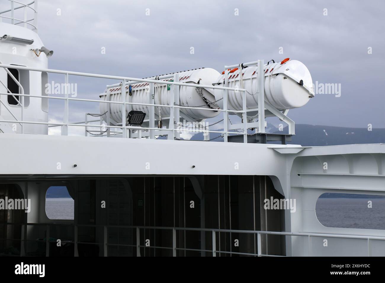 Norway fiord electric ferry crossing. Life boat capsules on passenger ...