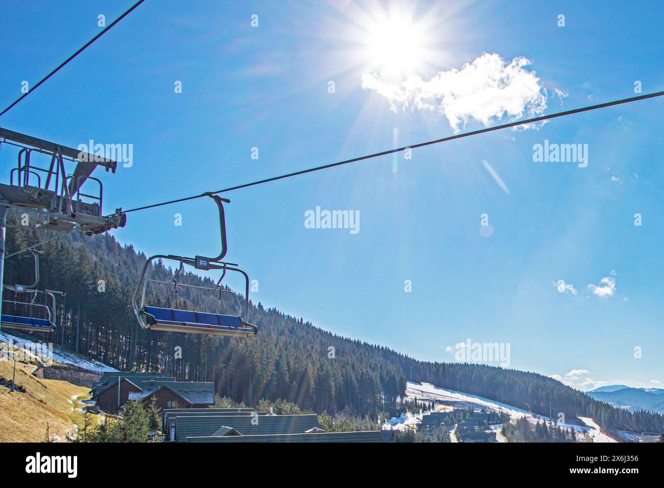 chairs on ski working lift. active family holiday Stock Photo - Alamy
