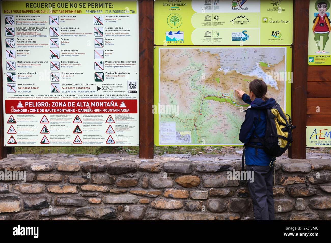 PYRENEES, SPAIN - SEPTEMBER 25, 2021: Tourist points to hiking trail ...