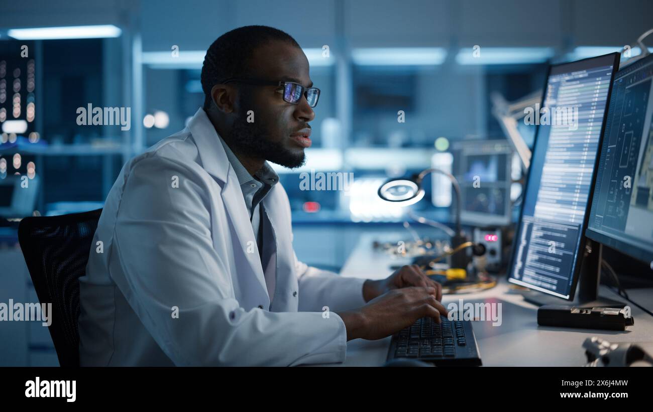 Modern Electronics Development Facility: Male Engineer Works on ...