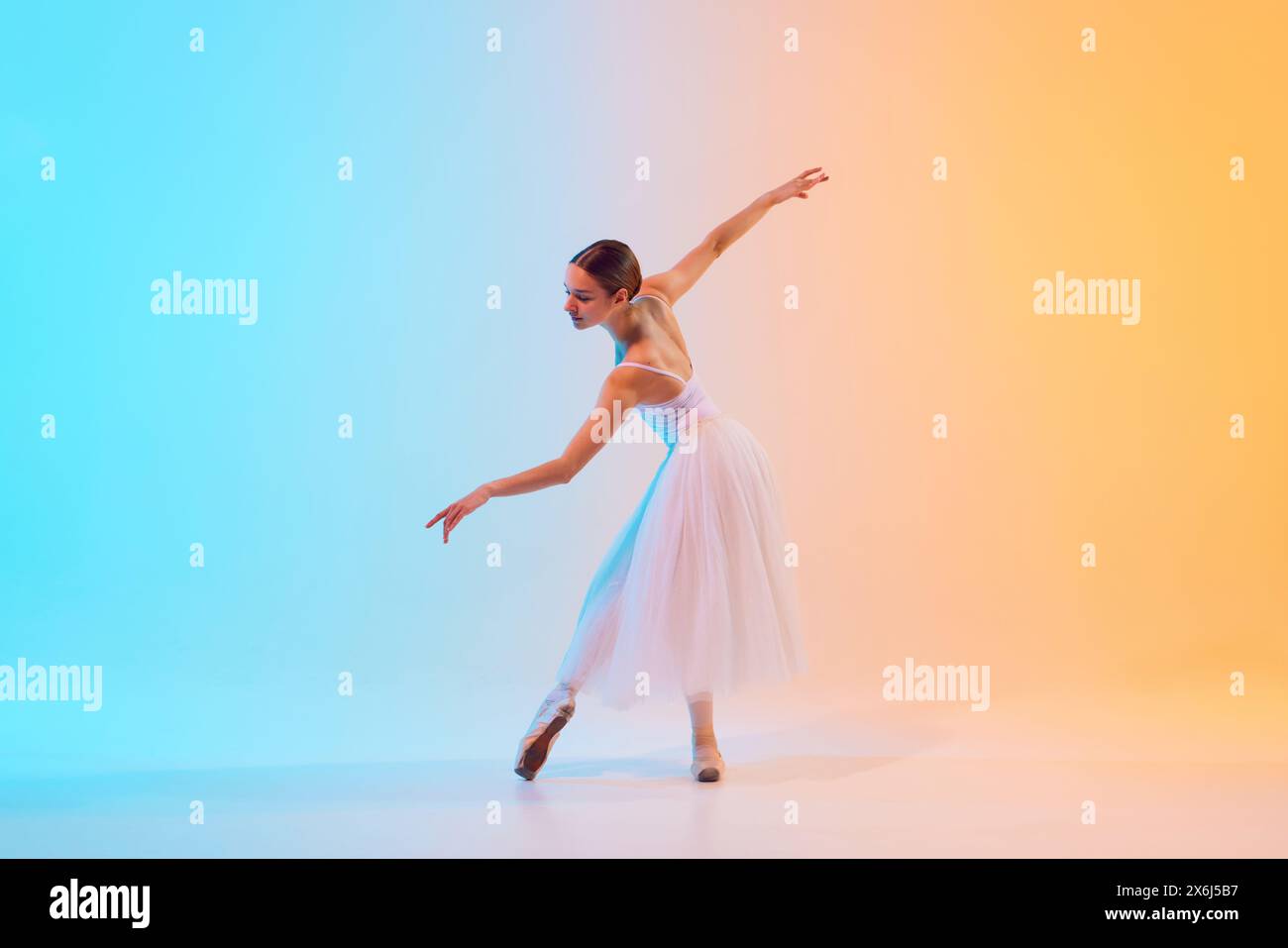 Grace in motion. Charming, young ballerina in classic ballet pose in ...