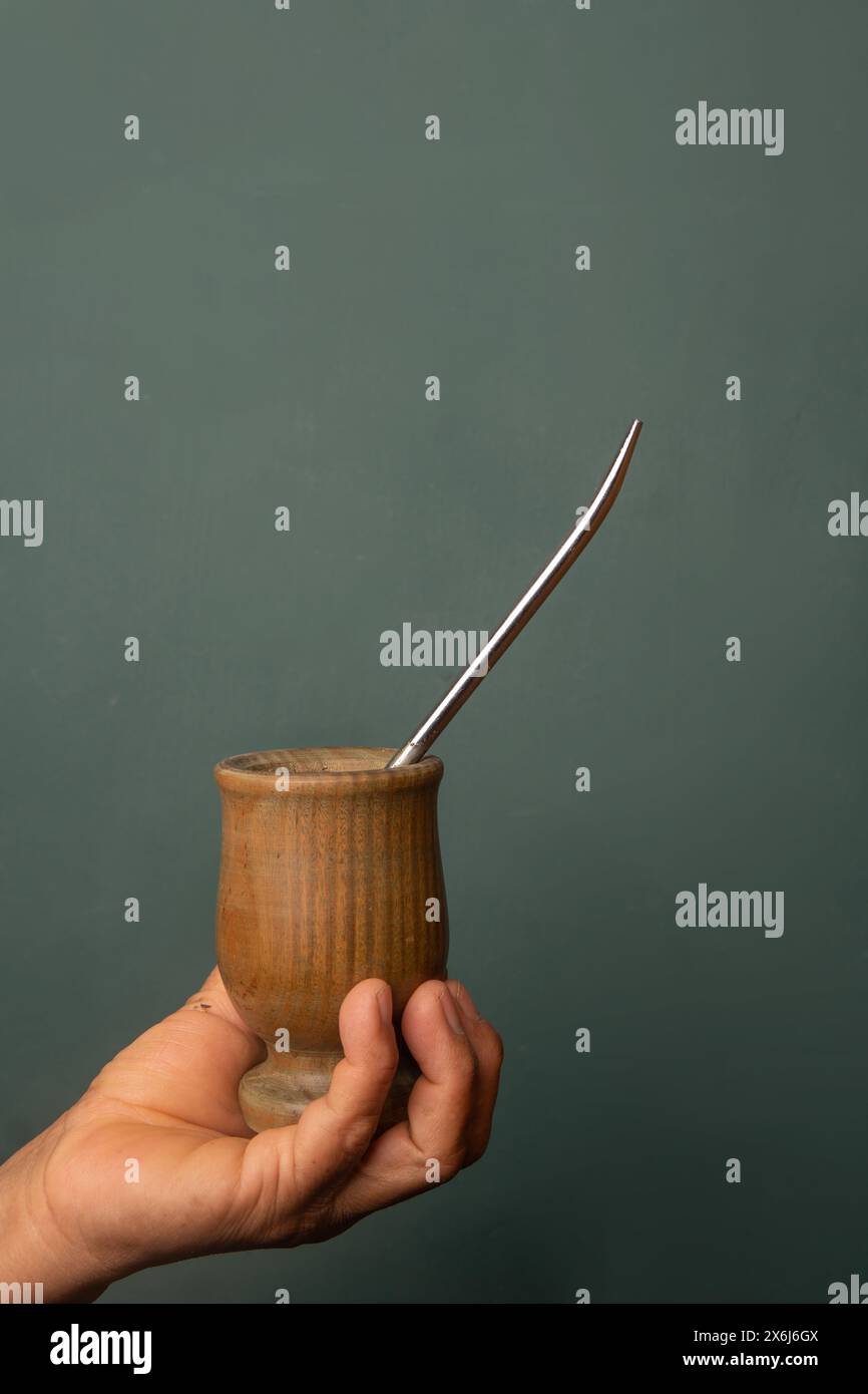 A hand holding a Mate with Yerba Mate, traditional Brazilian ...