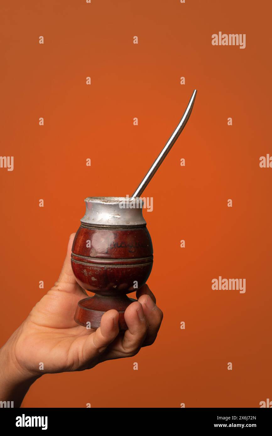 A hand holding a Mate with Yerba Mate, traditional Brazilian ...