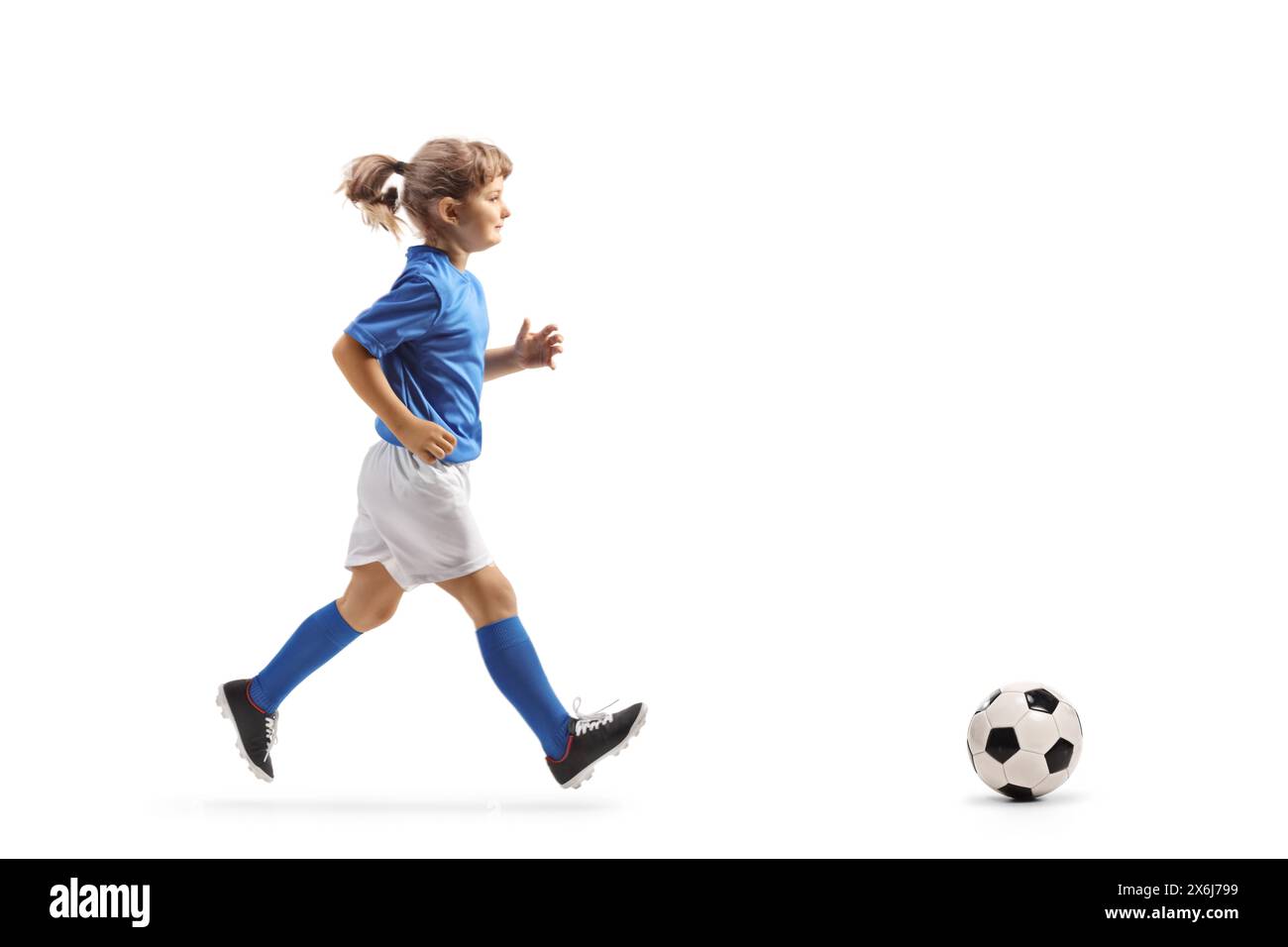 Full length profile shot of a girl in a football jersey running after a ...