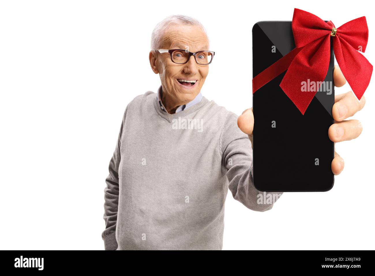 Happy male pensioner with a mobile phone prize isolated on white ...