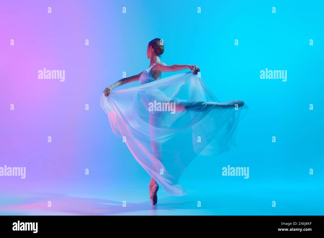 Ballet dancer with flowing white fabric captured in dynamic pose in ...