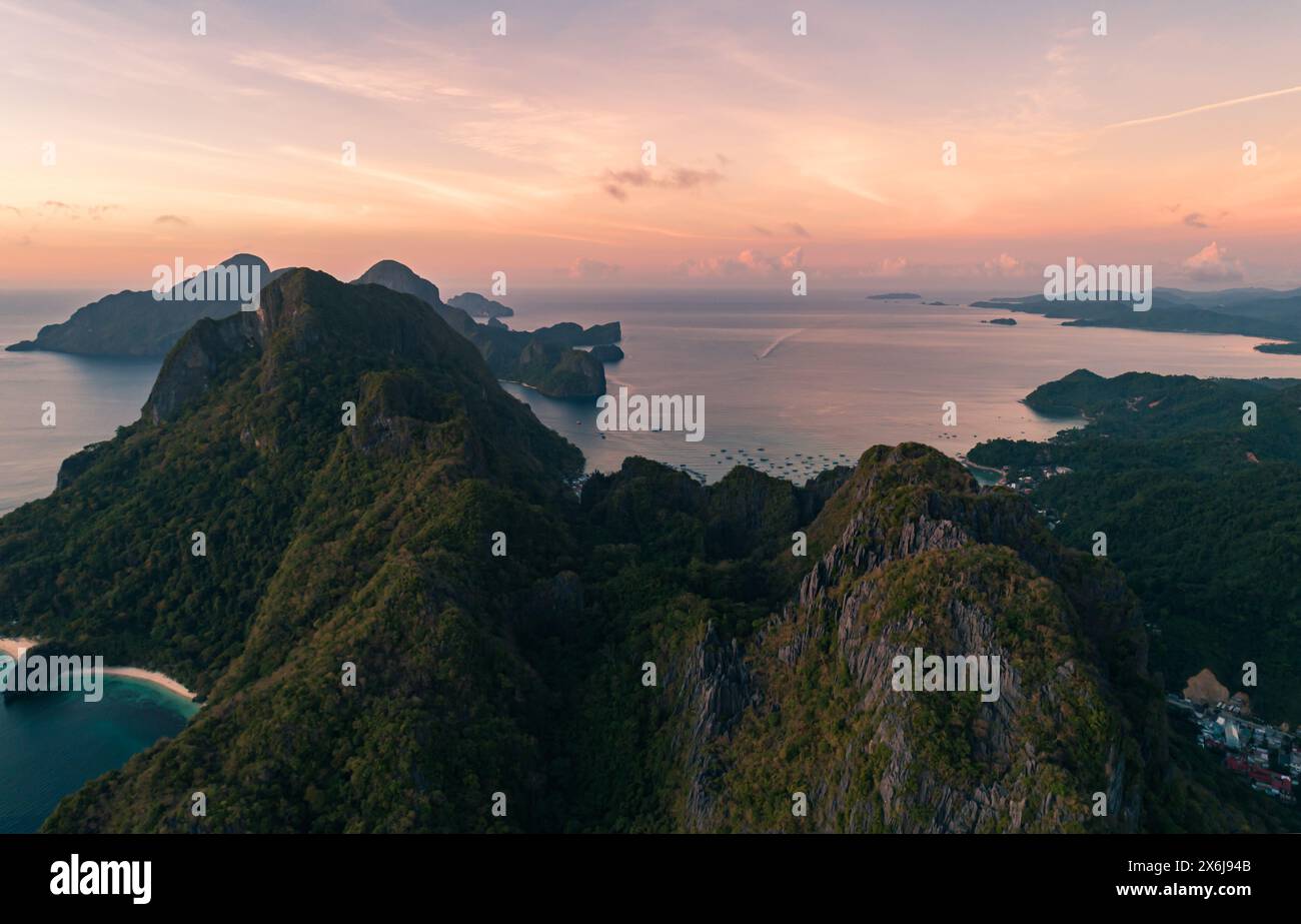 Aerial view of tropical islands at sunset in calm ocean. Palawan ...
