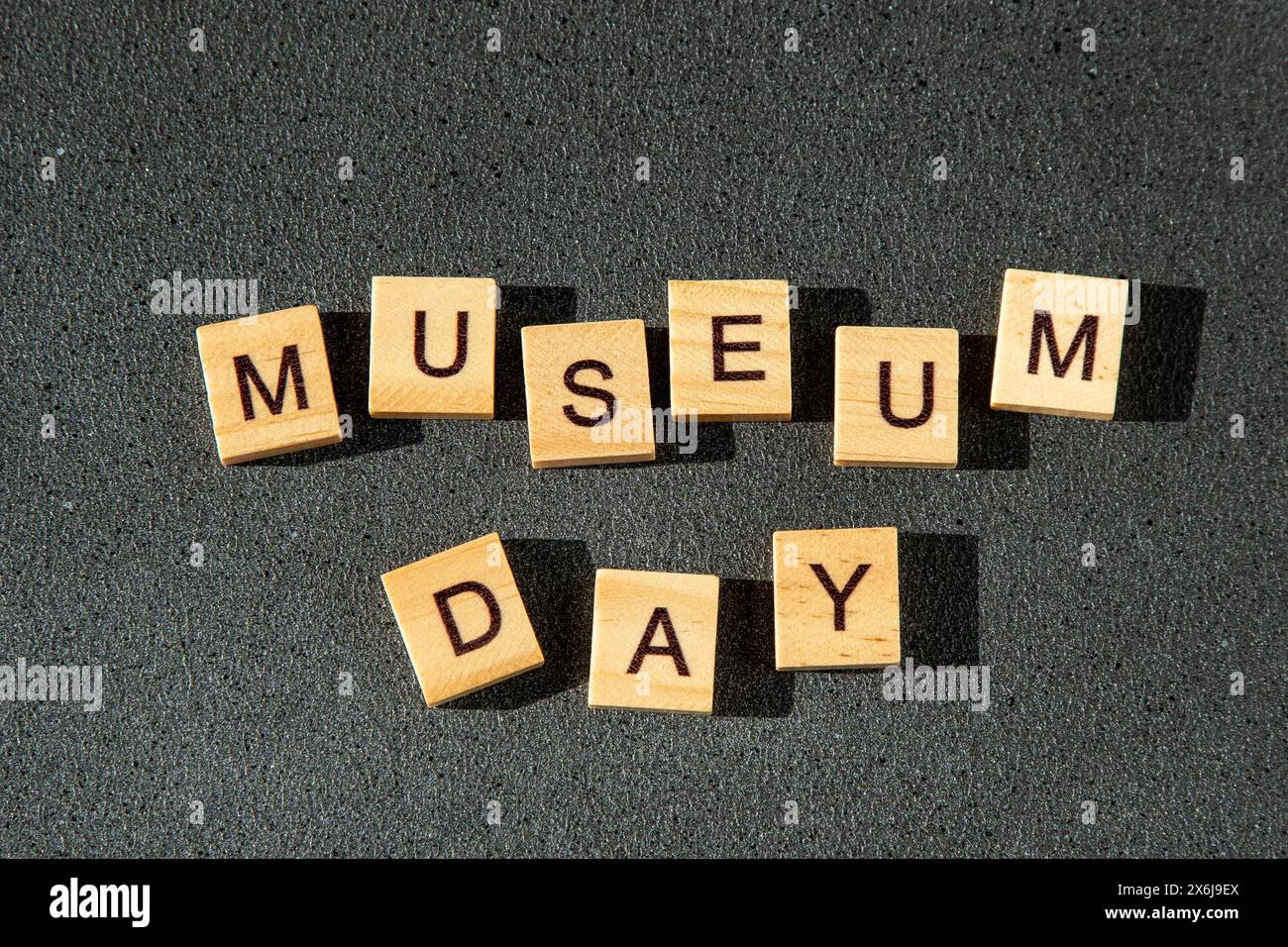 Museum day wooden letters text black background. 18 May Stock Photo - Alamy