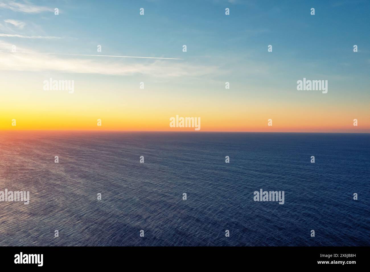 Sunset over sea water. The blue sea goes beyond the horizon Stock Photo ...