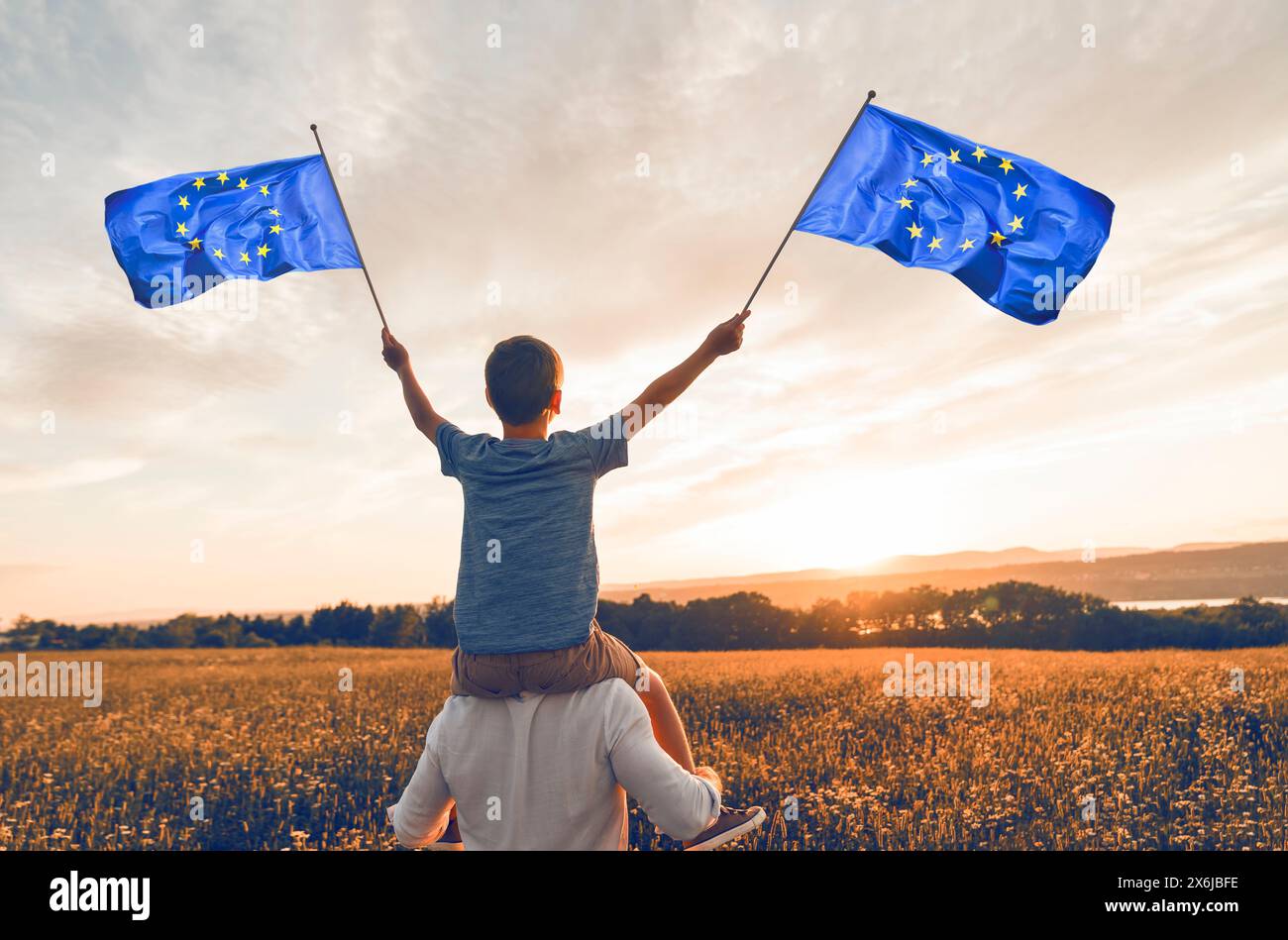 Patriotic father and child waving European Union flag on sunset Stock ...