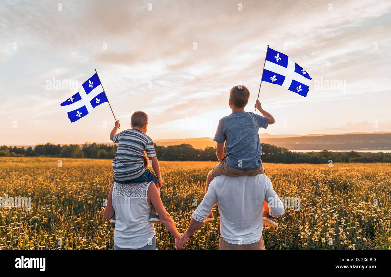 Patriotic family waving Quebec flags on sunset Stock Photo - Alamy