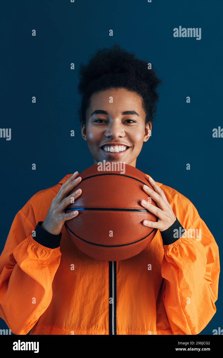 Portrait of a young smiling basketball player. Cheerful female in ...