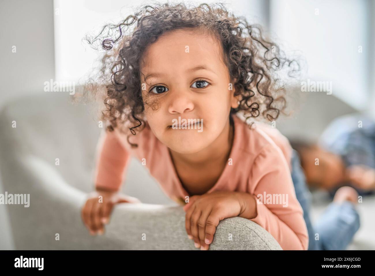 Little black girl concentrate watching tv alone in her living room ...