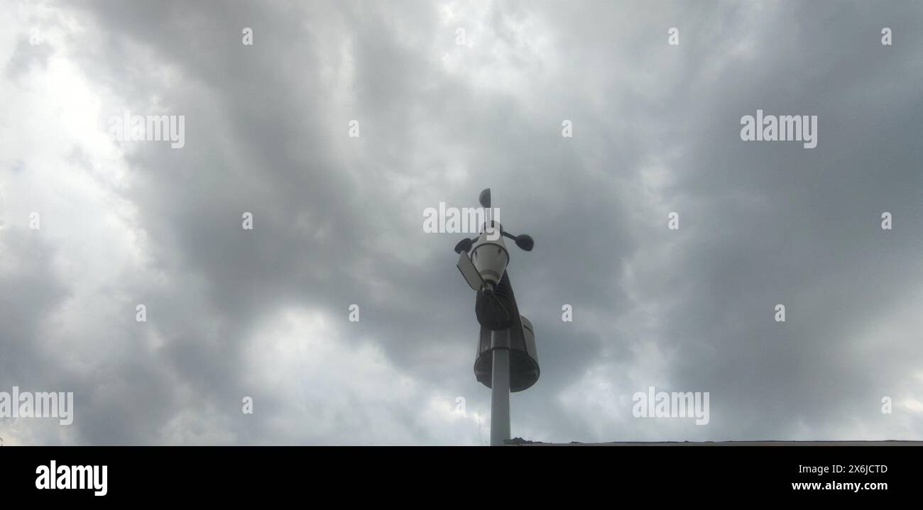 Spinning windmeter or anemometer with a dramatic sky as background ...