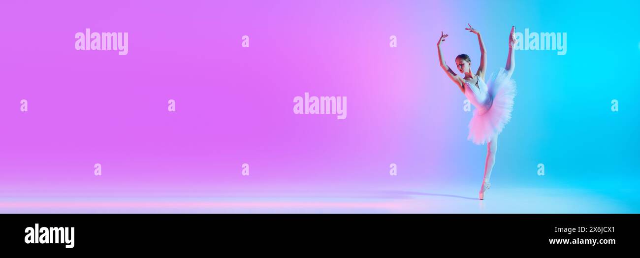 Gorgeous young ballet dancer standing on tiptoe and reaching up in ...