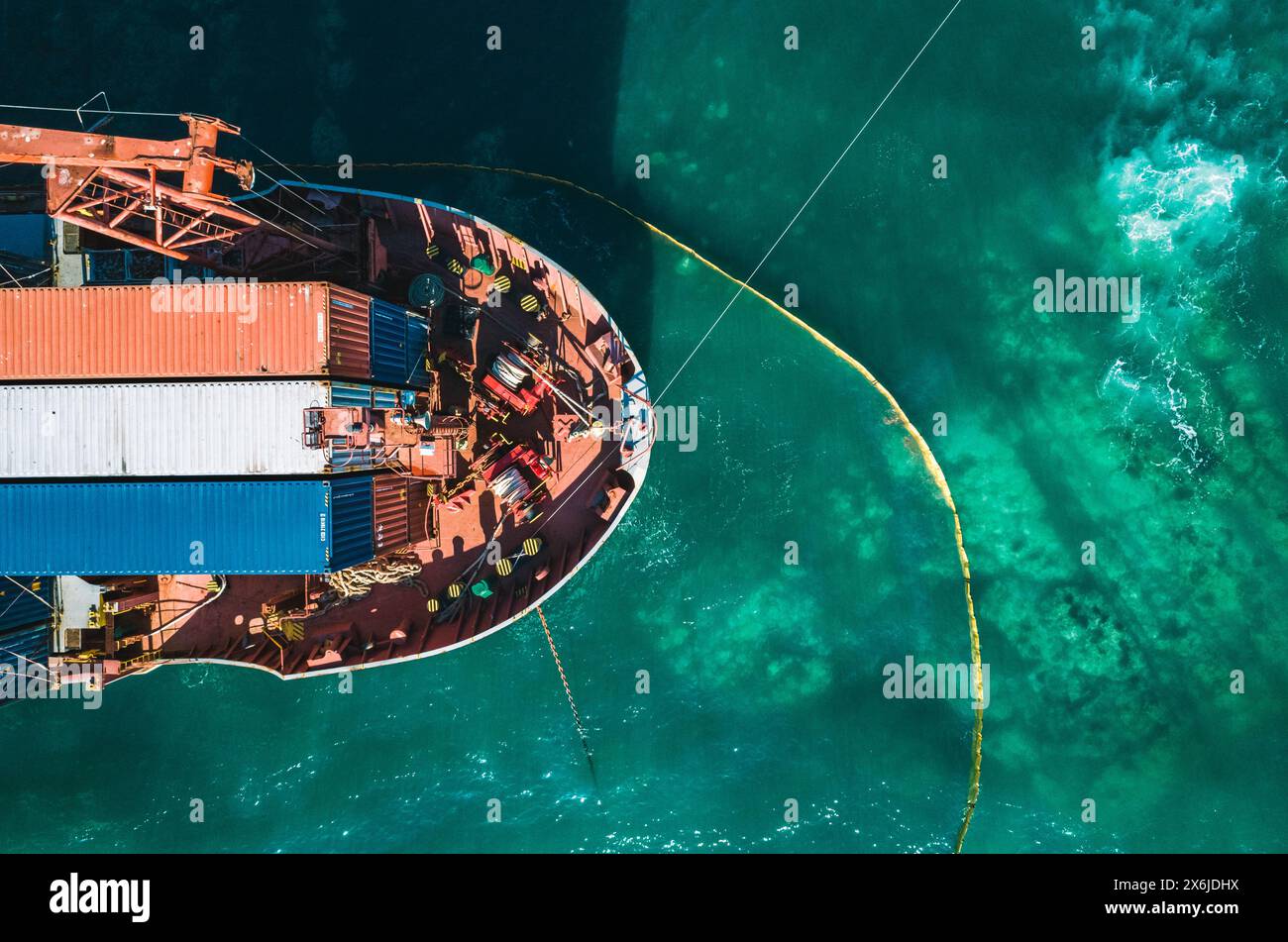 Aerial view of a container cargo ship stands aground after a storm with ...