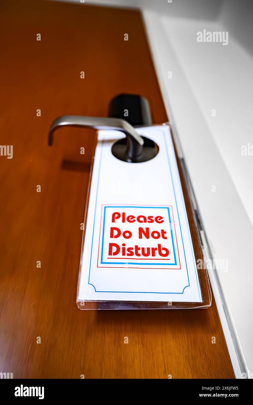 Do not disturb sign on the door Stock Photo - Alamy