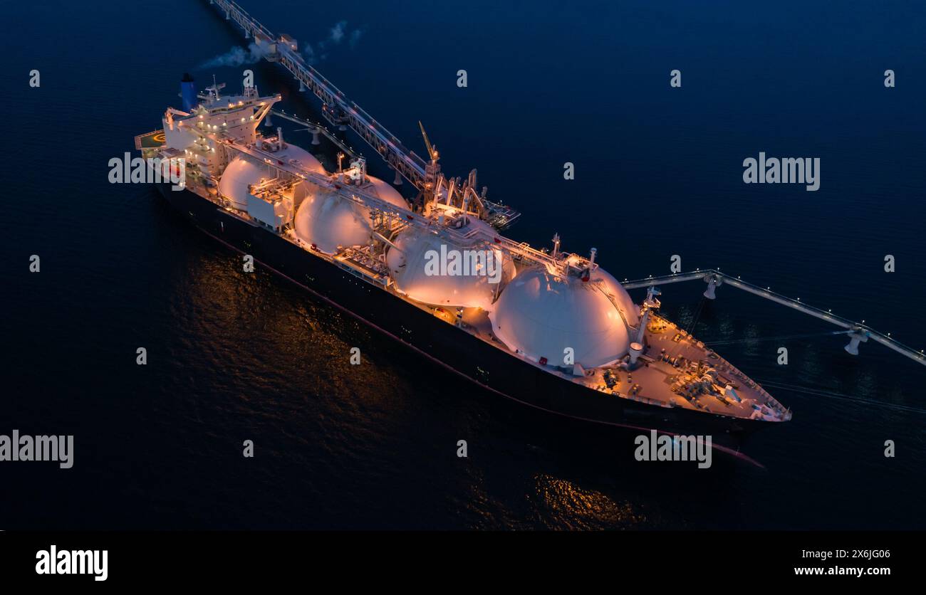 Aerial of Liquified Natural Gas LNG carrier moored to a small gas ...