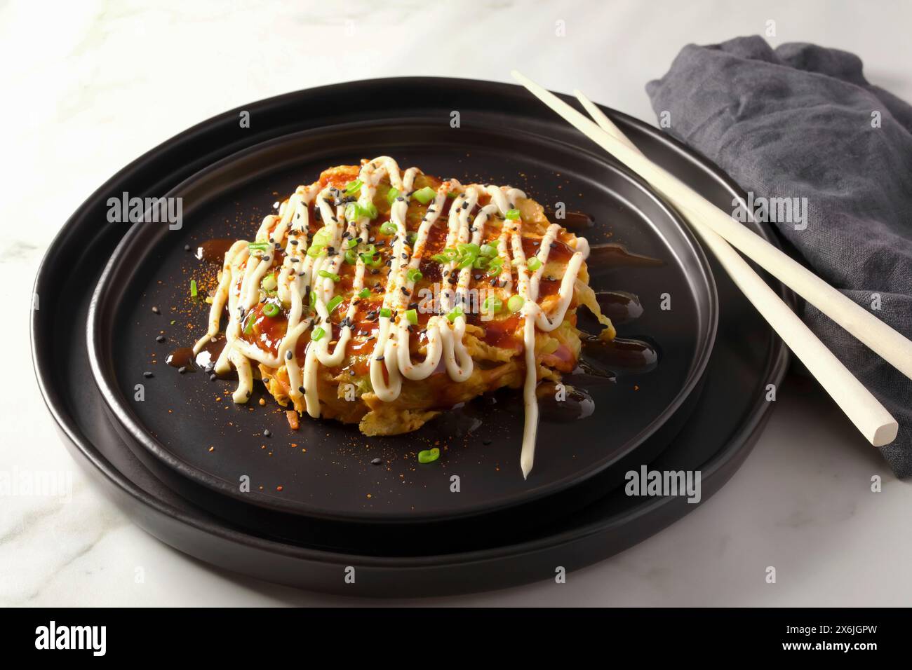 Japanese-style okonomiyaki omelette, garnished with okonomi sauce ...