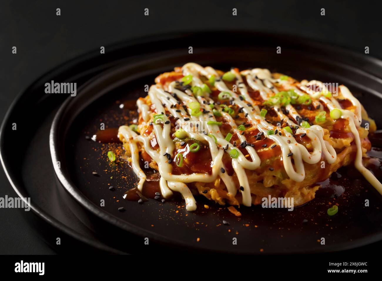 Japanese-style Okonomiyaki omelette, topped with Okonomi sauce ...