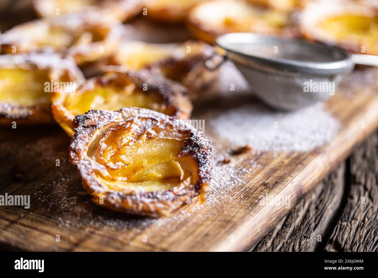 Mini tarts made of puff pastry and sliced apples sprinkled with ...