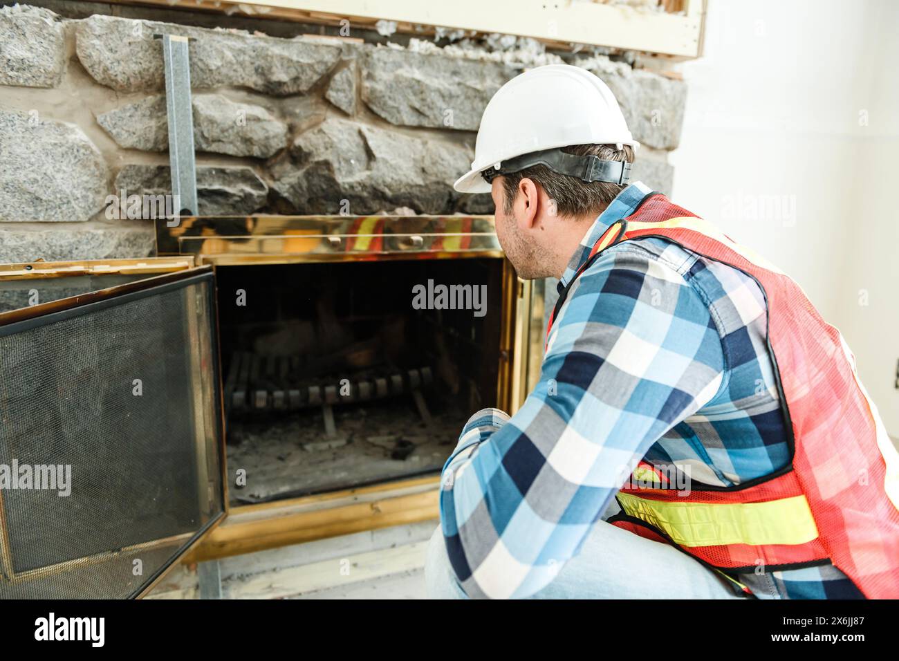 Inspector with white helmet inspecting an old house to be sure ...
