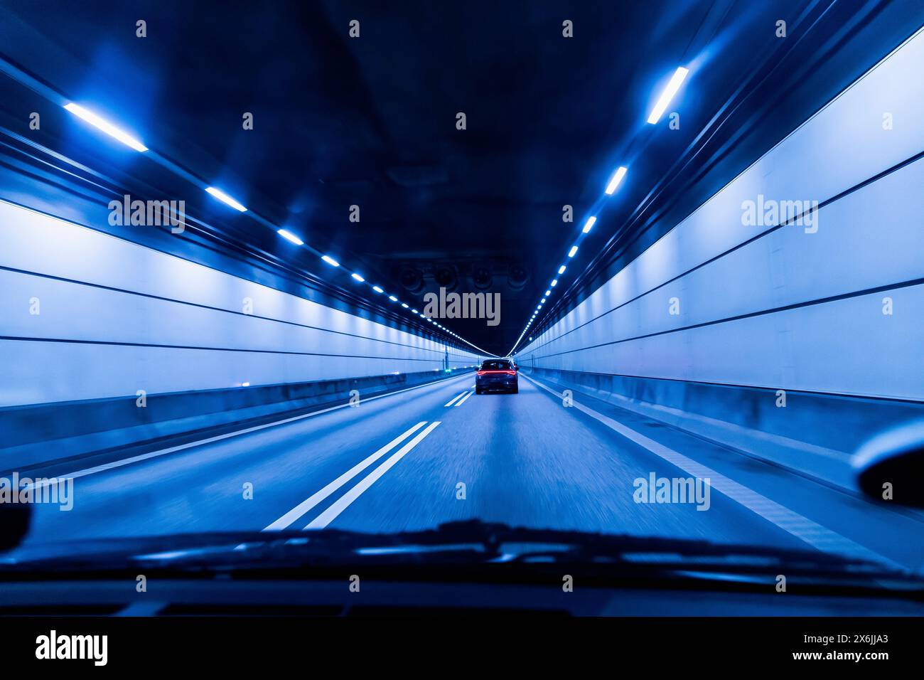 High-speed road tunnel view from a fast-moving car. Road and railway ... High-speed road tunnel view from a fast-moving car. Road and railway ...