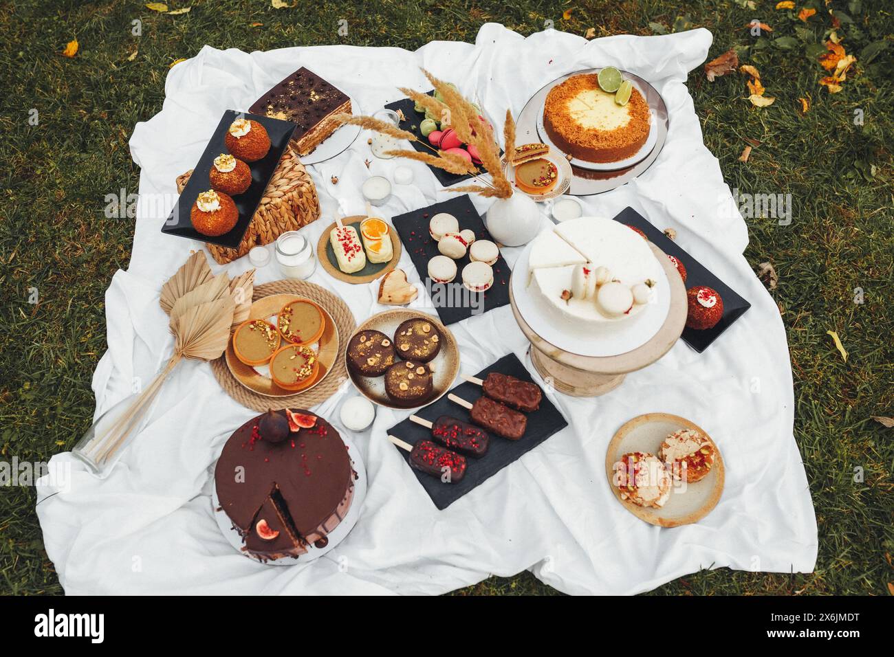Sweet Symphony: Decadent Desserts on a Picnic Table Stock Photo - Alamy