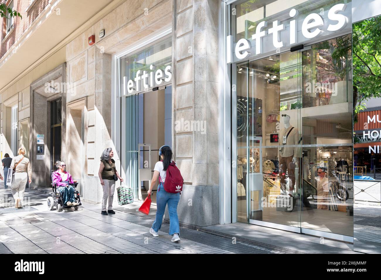 Pedestrians walk past the Spanish fashion brand owned by Inditex ...