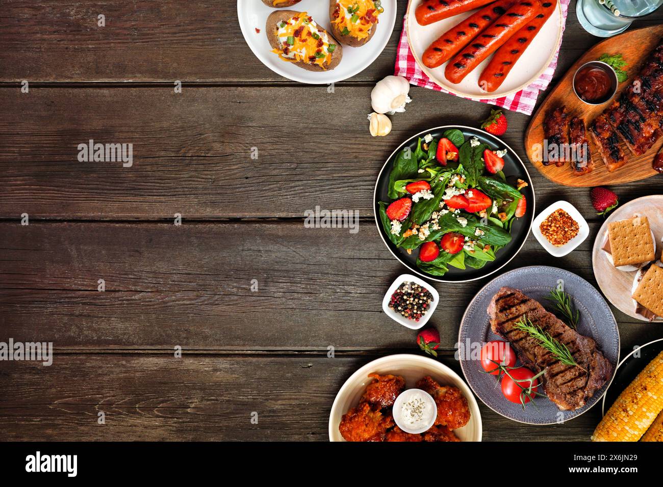 Summer BBQ food side border over a dark wood background. Variety of ...