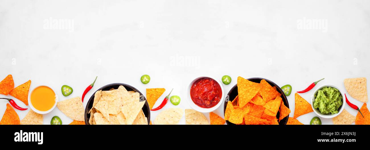 Nachos and dip bottom border. Top view on a white marble banner ...