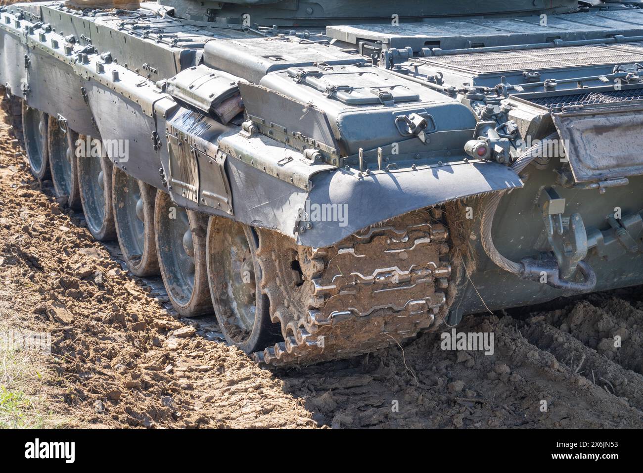 Camouflage tank with muddy tracks on the ground Stock Photo - Alamy