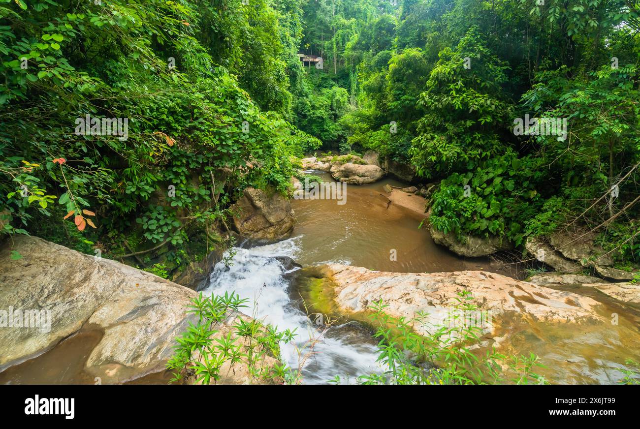Top view of river in rainforest flowing rapidly over large boulders ...
