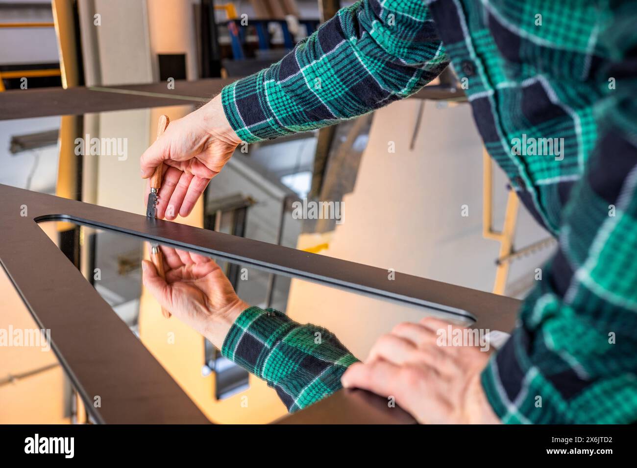 cutting glass in a glass factory, Glazier cuts mirror panes using a ...