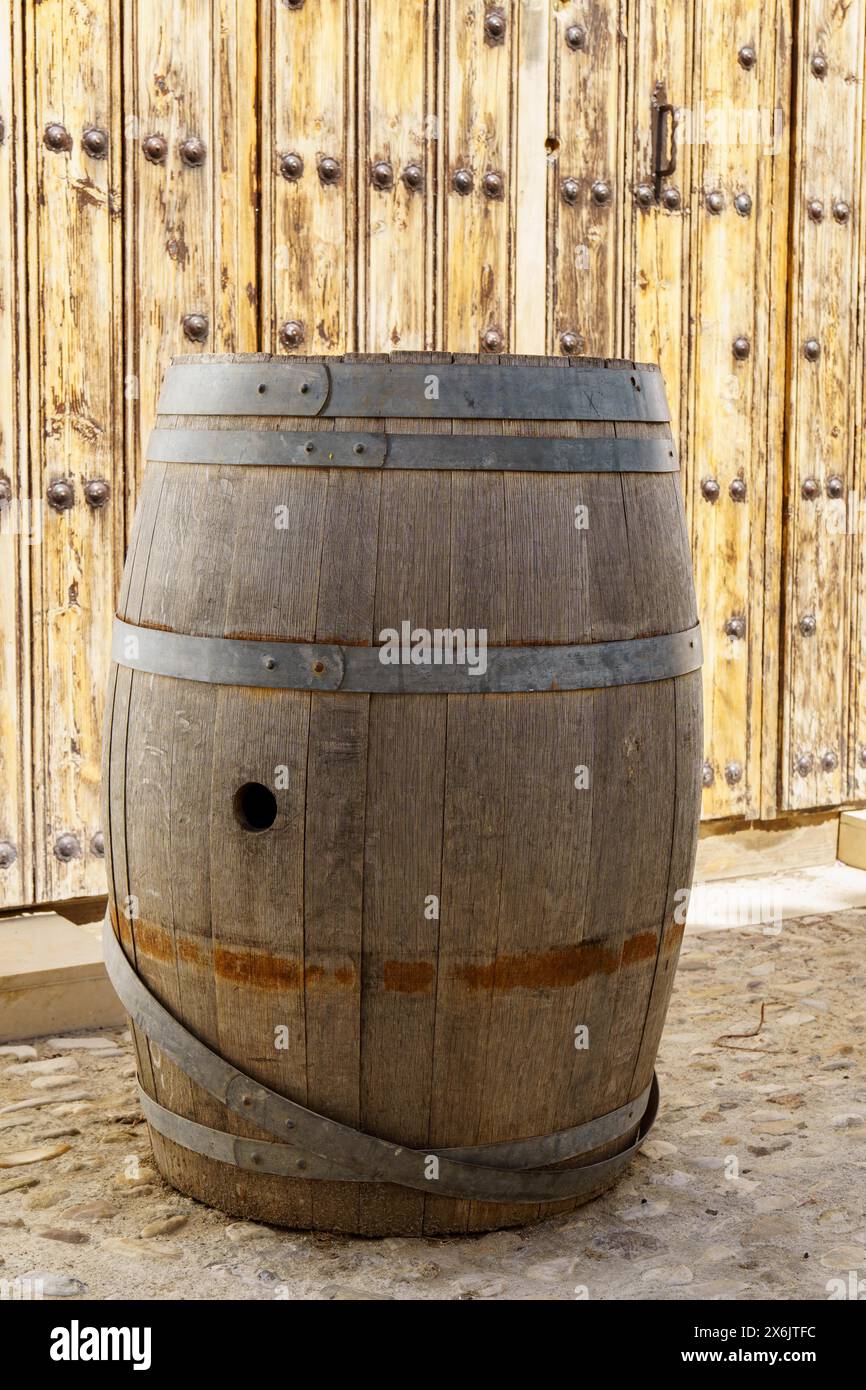 Old large wooden barrel on the street in front of a wooden door Stock ...