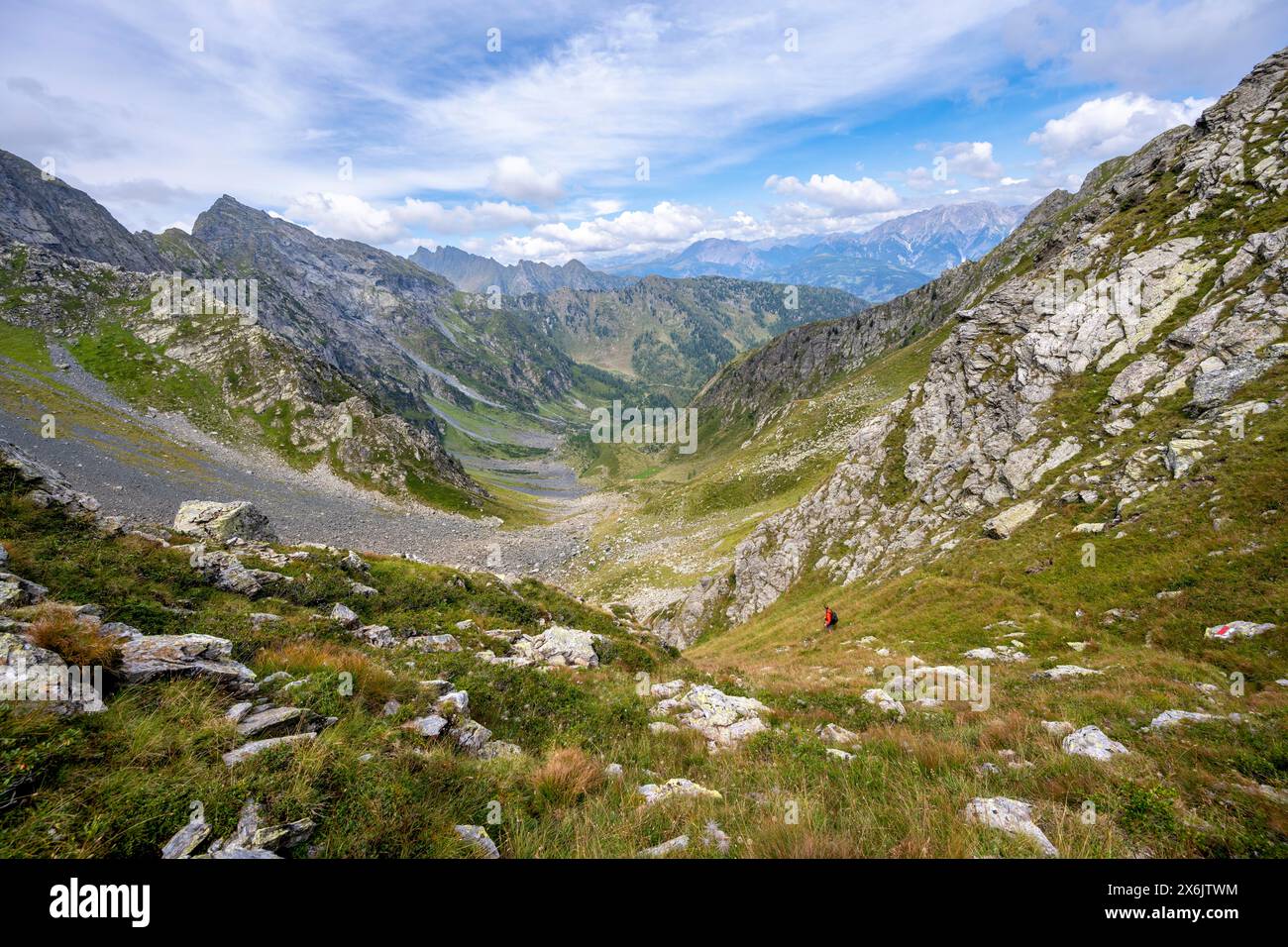 Mountaineer on a hiking trail at a saddle, view into the Obergailtal ...