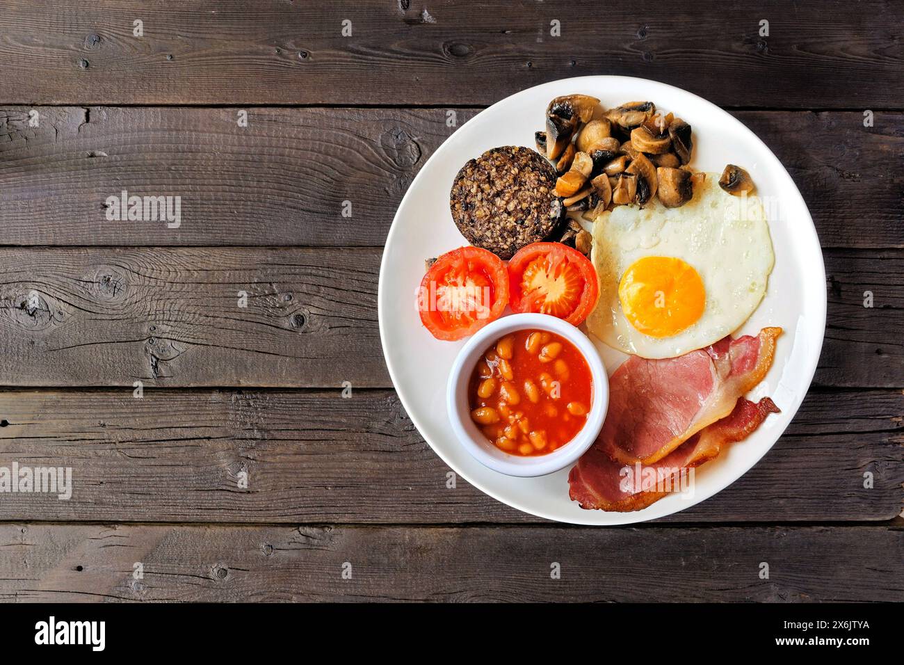 Full Scottish breakfast with haggis. Top view over a rustic dark wood ...