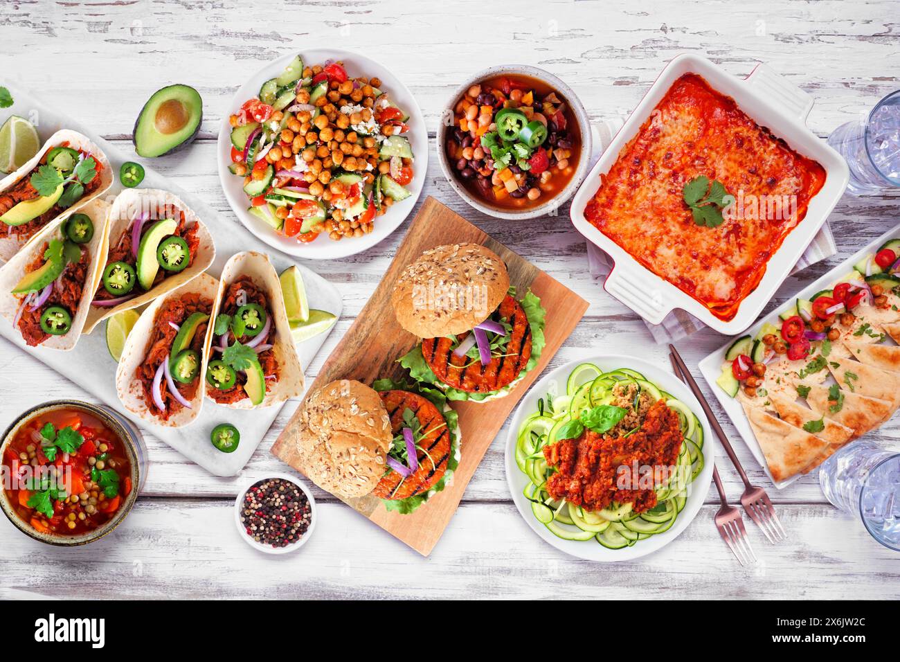 Healthy plant based vegetarian meal table scene. Top view on a white ...