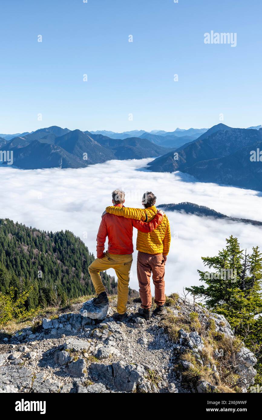 Two friends put their arms around each other's shoulders, mountaineers ...